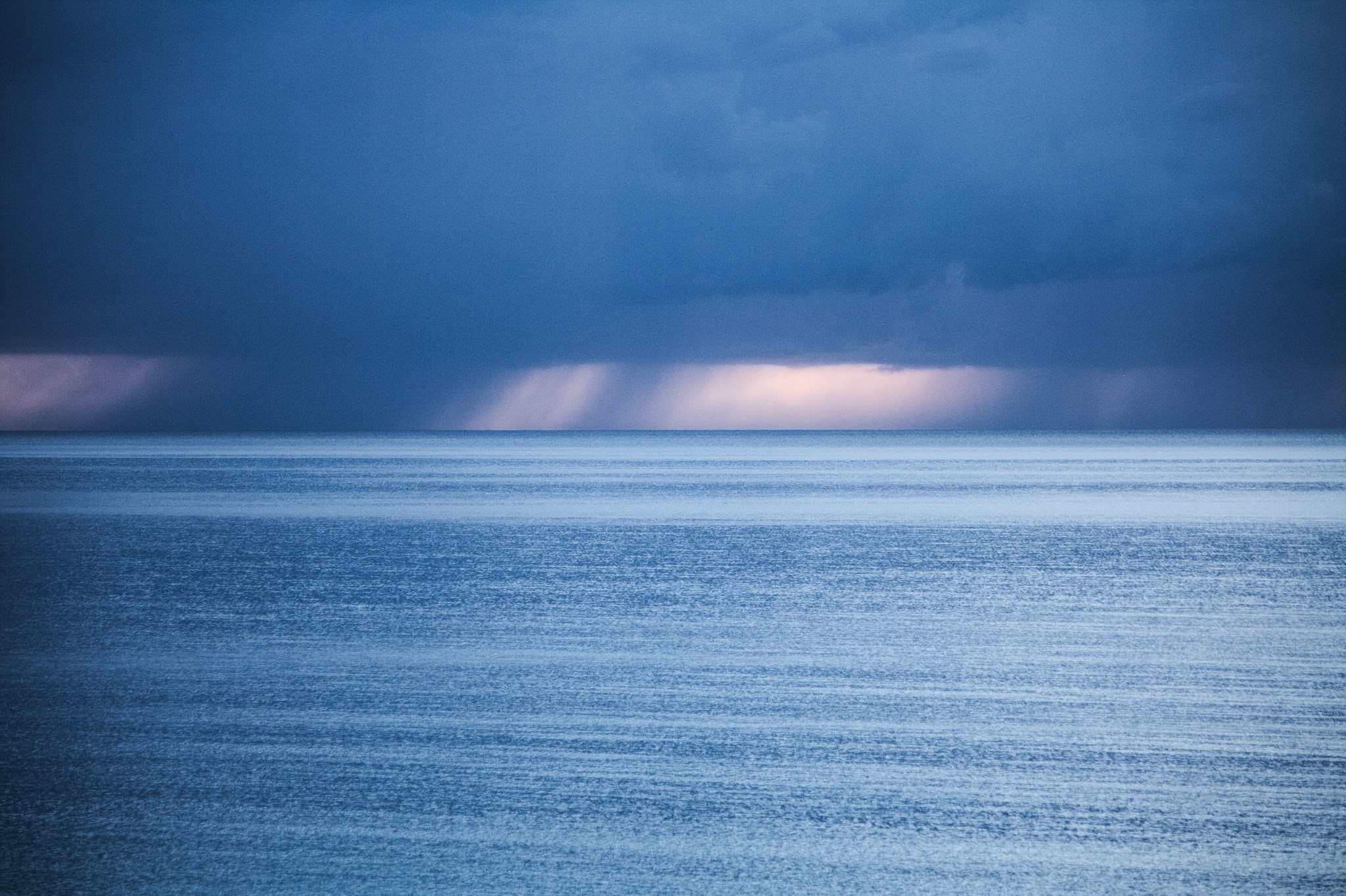 Regen über dem Meer in Cancún | David Scherfgen